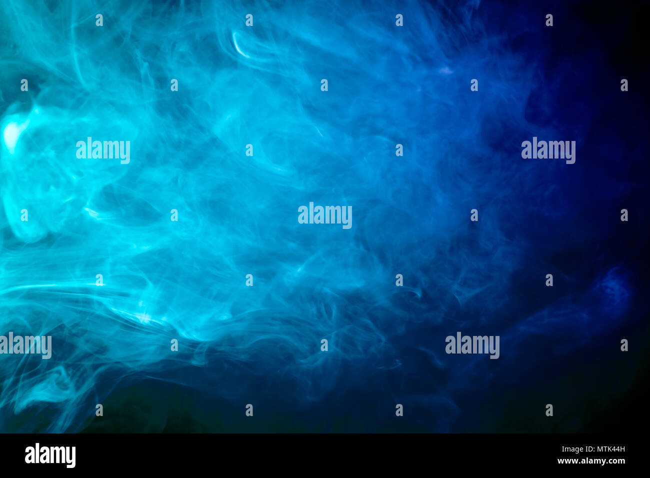 Thick colorful blue smoke on a black isolated background. Background ...