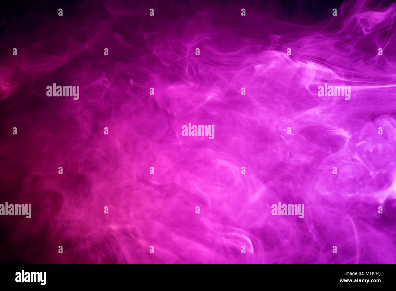 Thick colorful pink smoke on a black isolated background. Background ...