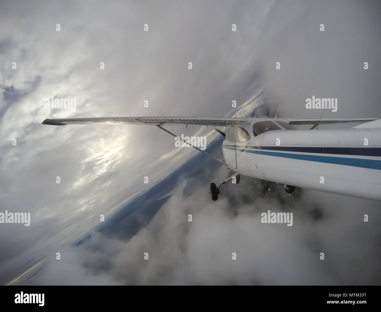Airplane flying over the beautiful Canadian Mountain Landscape during a ...