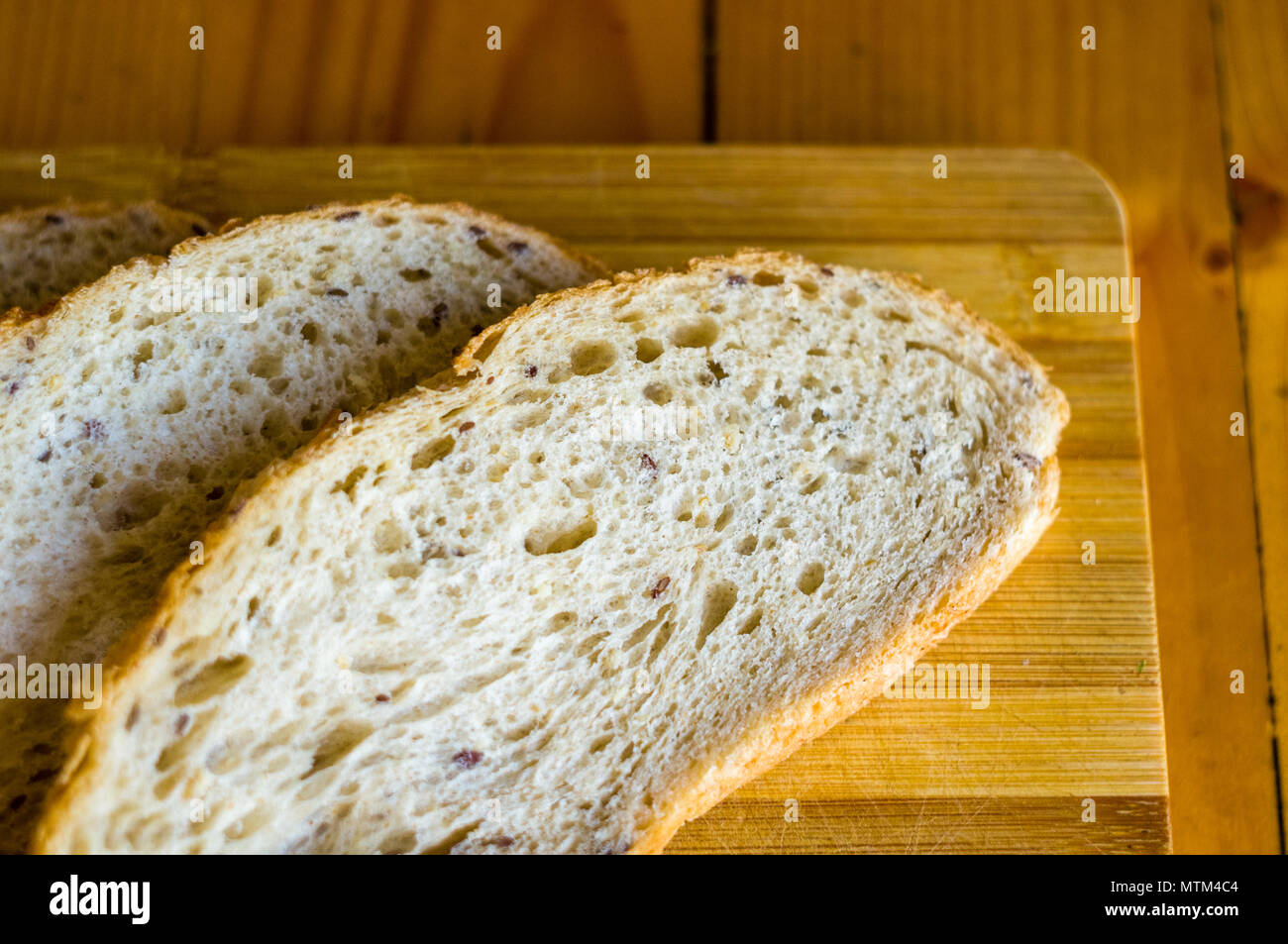 sliced whole wheat breads on a chopping Board Stock Photo - Alamy
