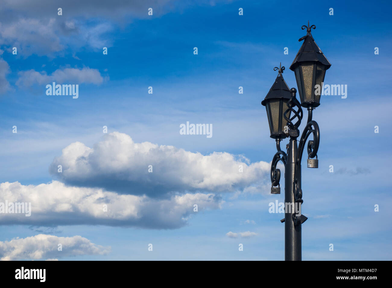city skyline - classic lamp post with locks of lovers at sunset Stock ...