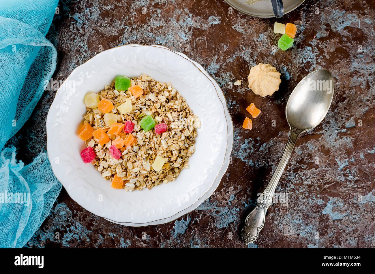 Healthy Breakfast of homemade Granola in white plate with colored ...