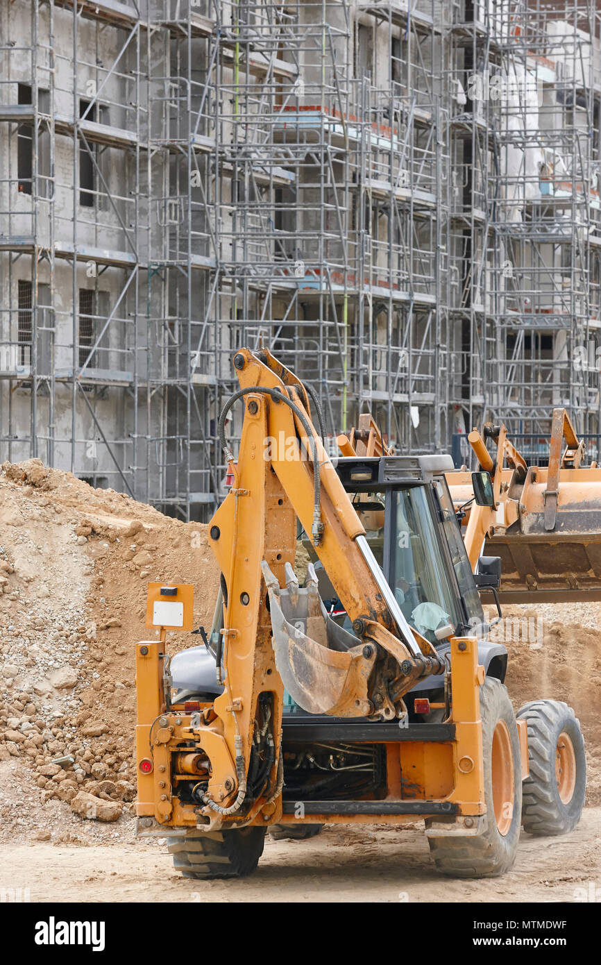 Excavator on a construction site. Building in progress. Architecture ...