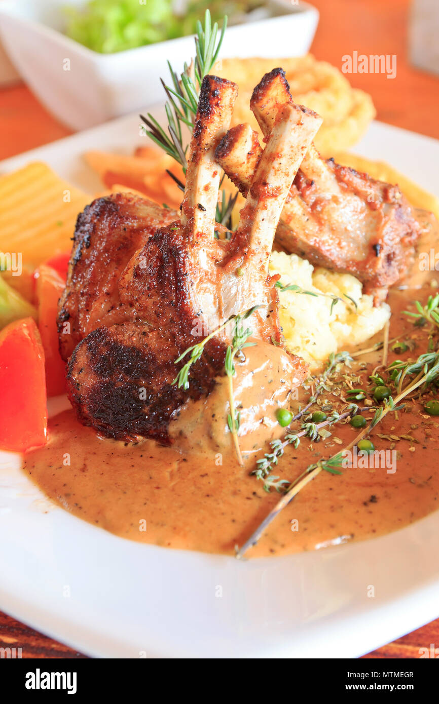 Lamb steak in white dish Stock Photo - Alamy