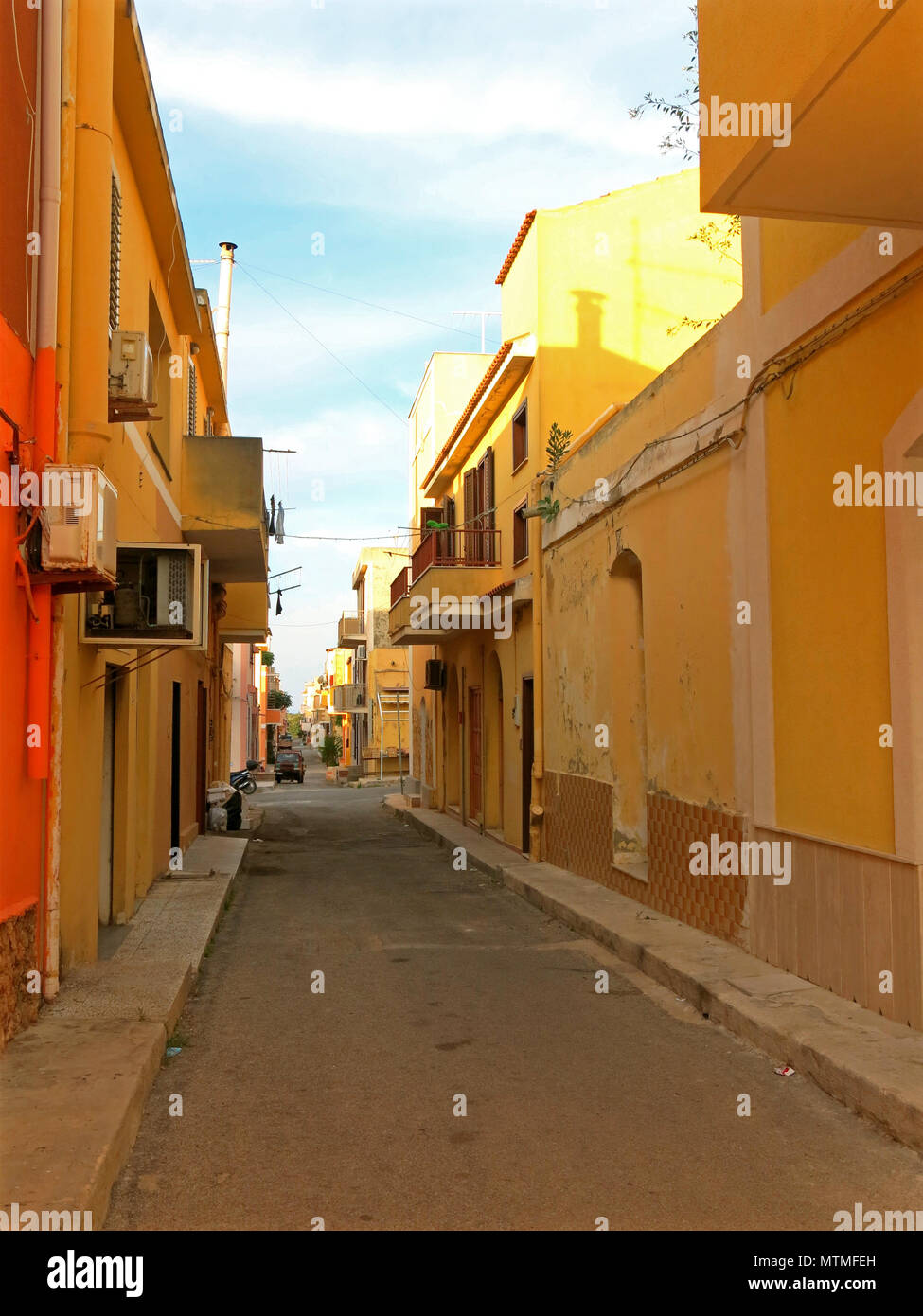 Narrow alley of a typical southern Italian city with colorful houses ...