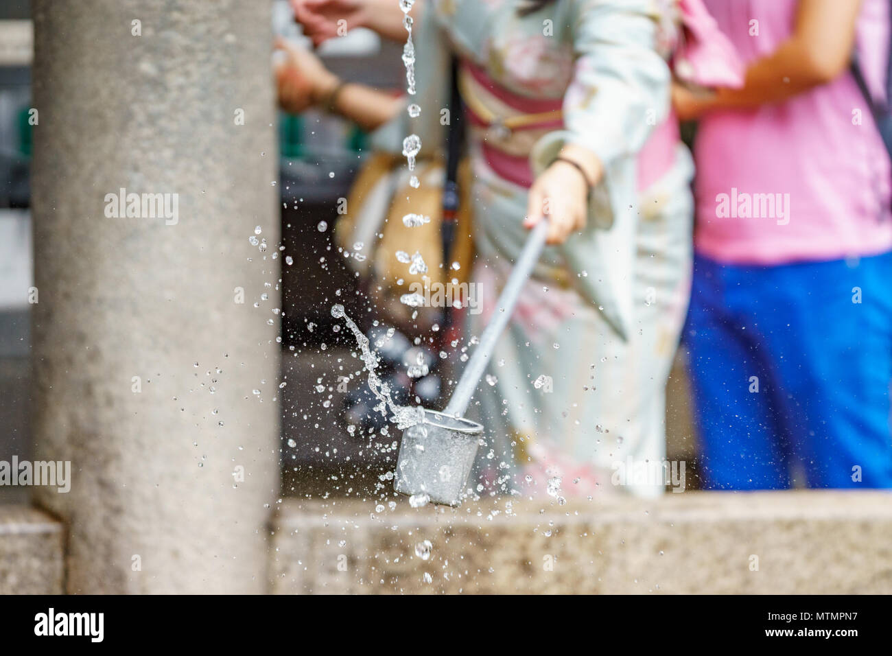 Sparkling water purification at entrance of Japanese temple Stock Photo ...