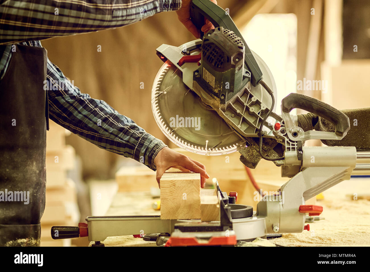 Man using miter saw to cut wood hi-res stock photography and images - Alamy