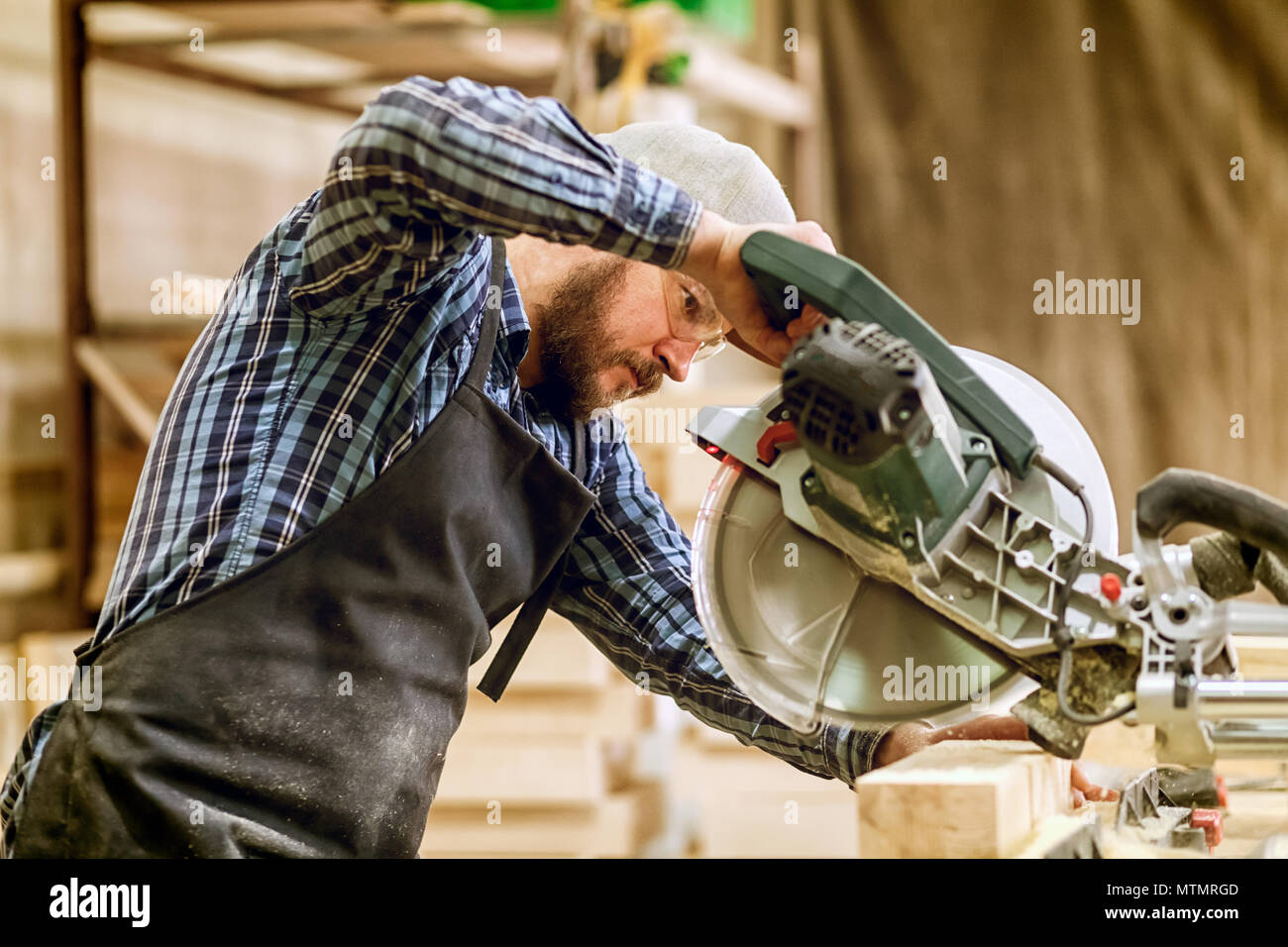 Carpenter work with circular saw for cutting boards, the man sawed bars ...