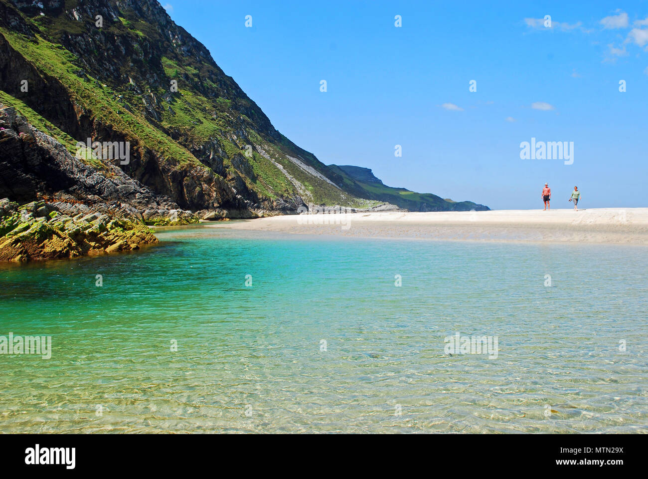 A couple walking along Maghera beach, Ardara, County Donegal, Ireland ...