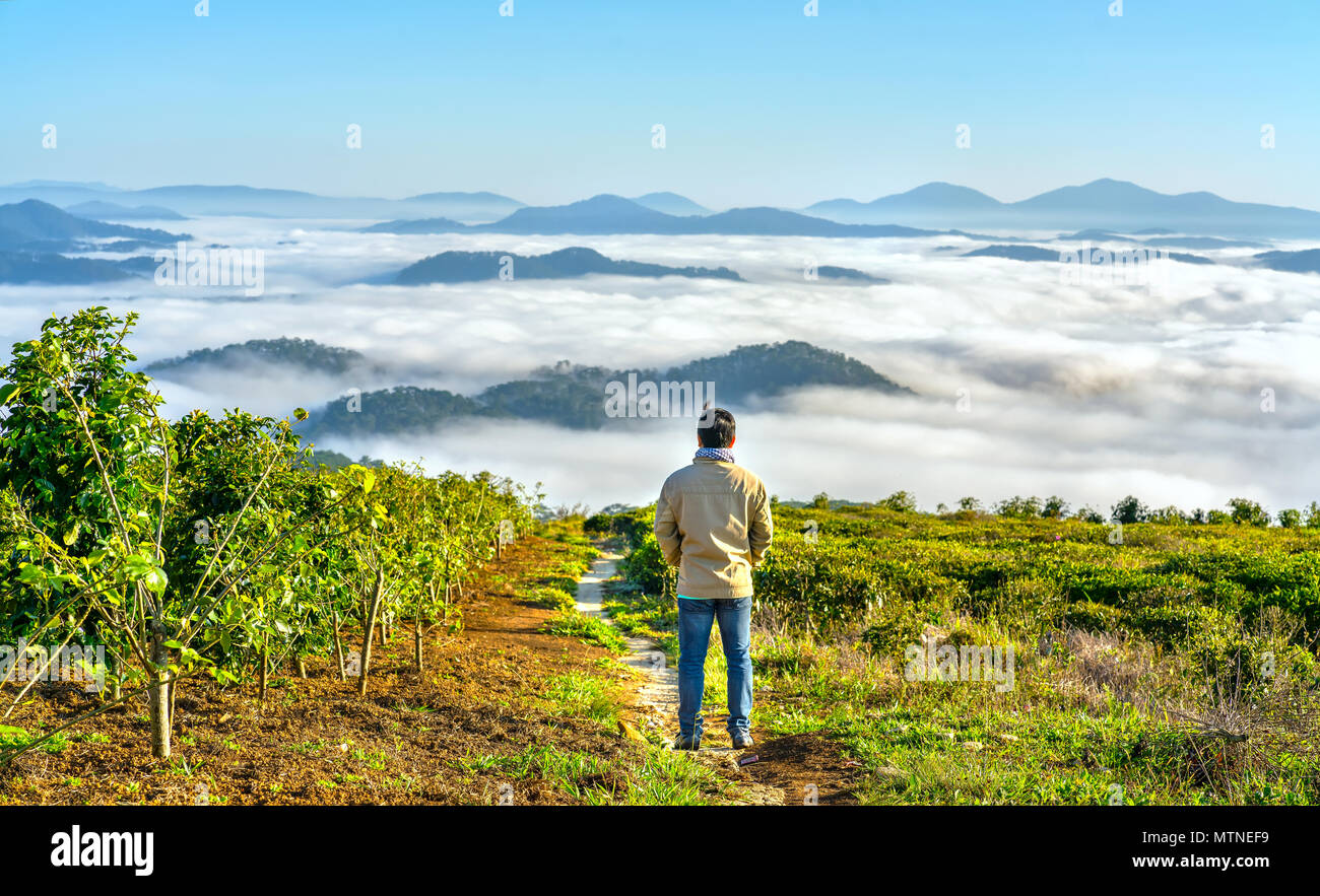 Silhouette young man standing on a high hill scenic rural hometown in ...