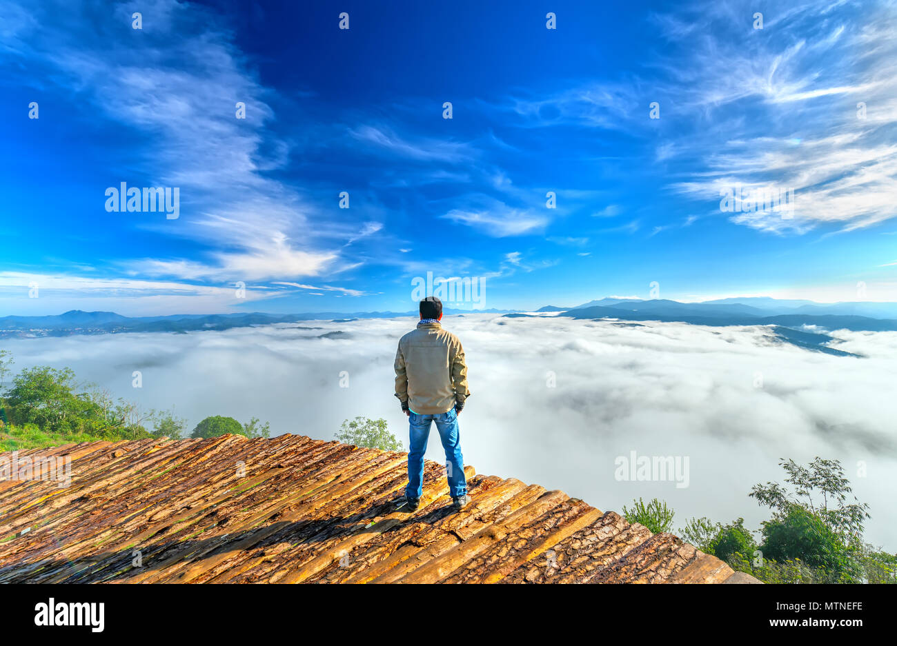 Silhouette young man standing on a high hill scenic rural hometown in ...