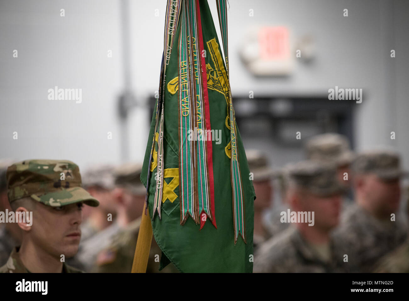 Soldiers of the 94th Military Police Company stand under their guidon ...