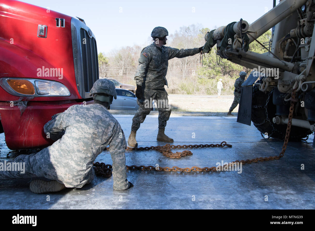 Alabama National Guard Soldiers attach an 18-wheeler to a wrecker on ...