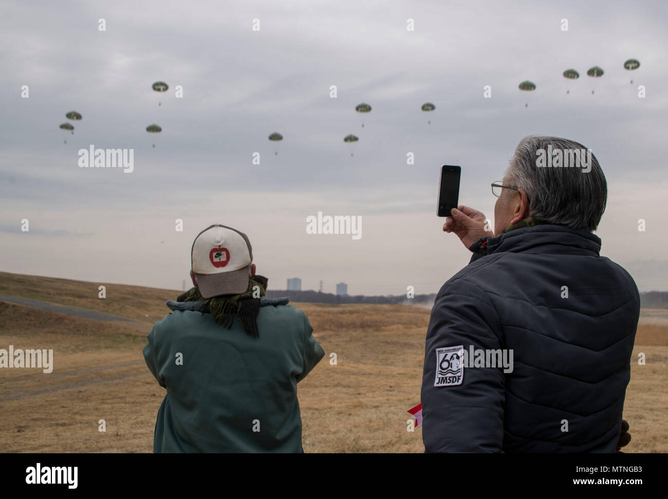Two Japanese citizens watch Japanese Ground Self Defense Force soldiers ...