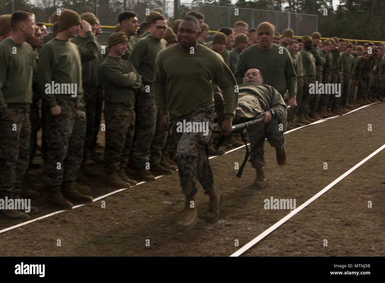 Marines participate in a stretcher relay-race as a part of a ...