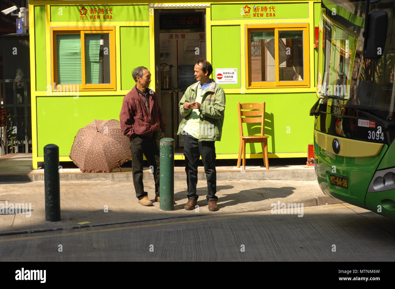 Two Chinese men waiting at a bus stop. 6,332 3 Stock Photo - Alamy