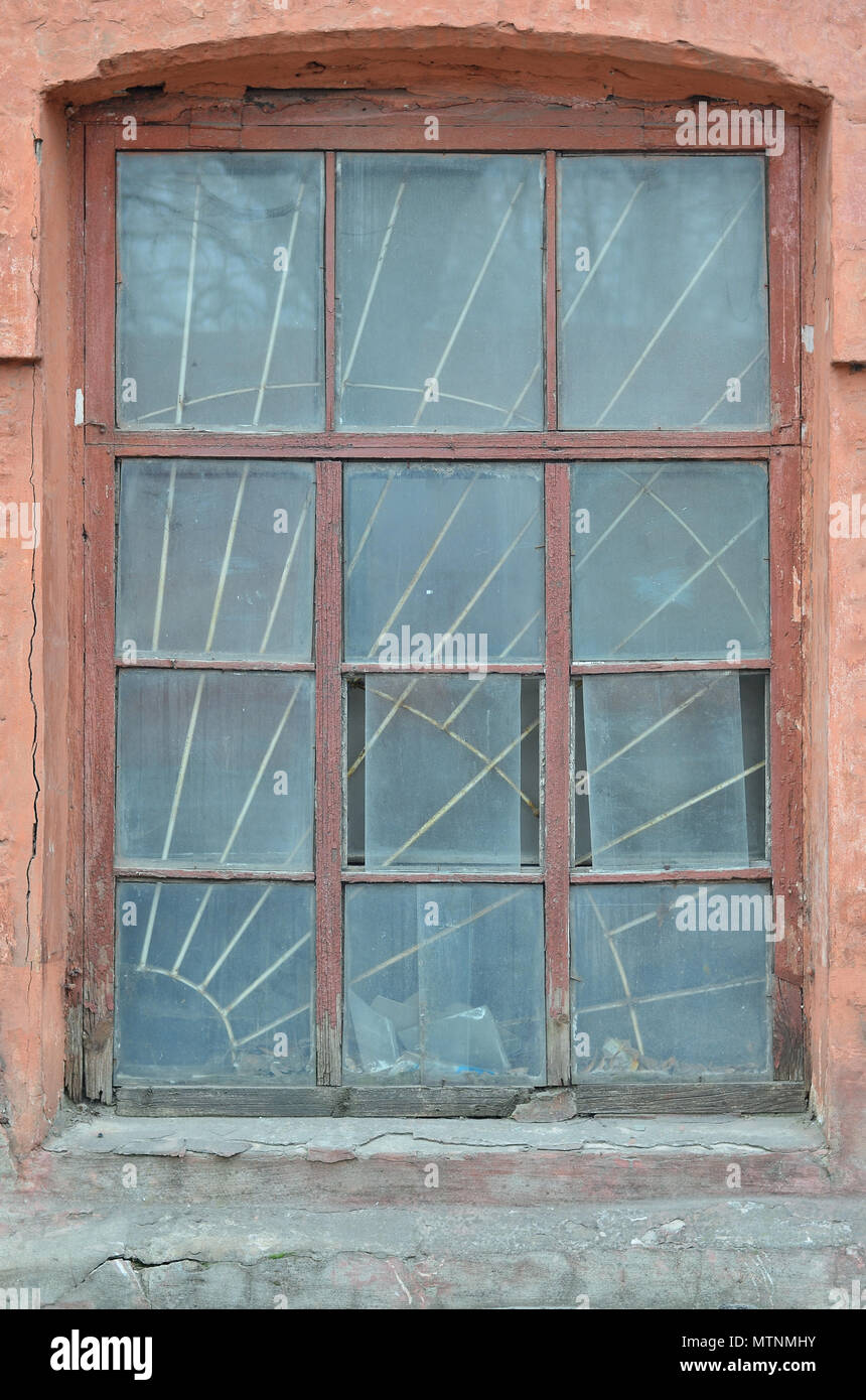 The texture of the old window in damaged red brick wall. The wall of an ...