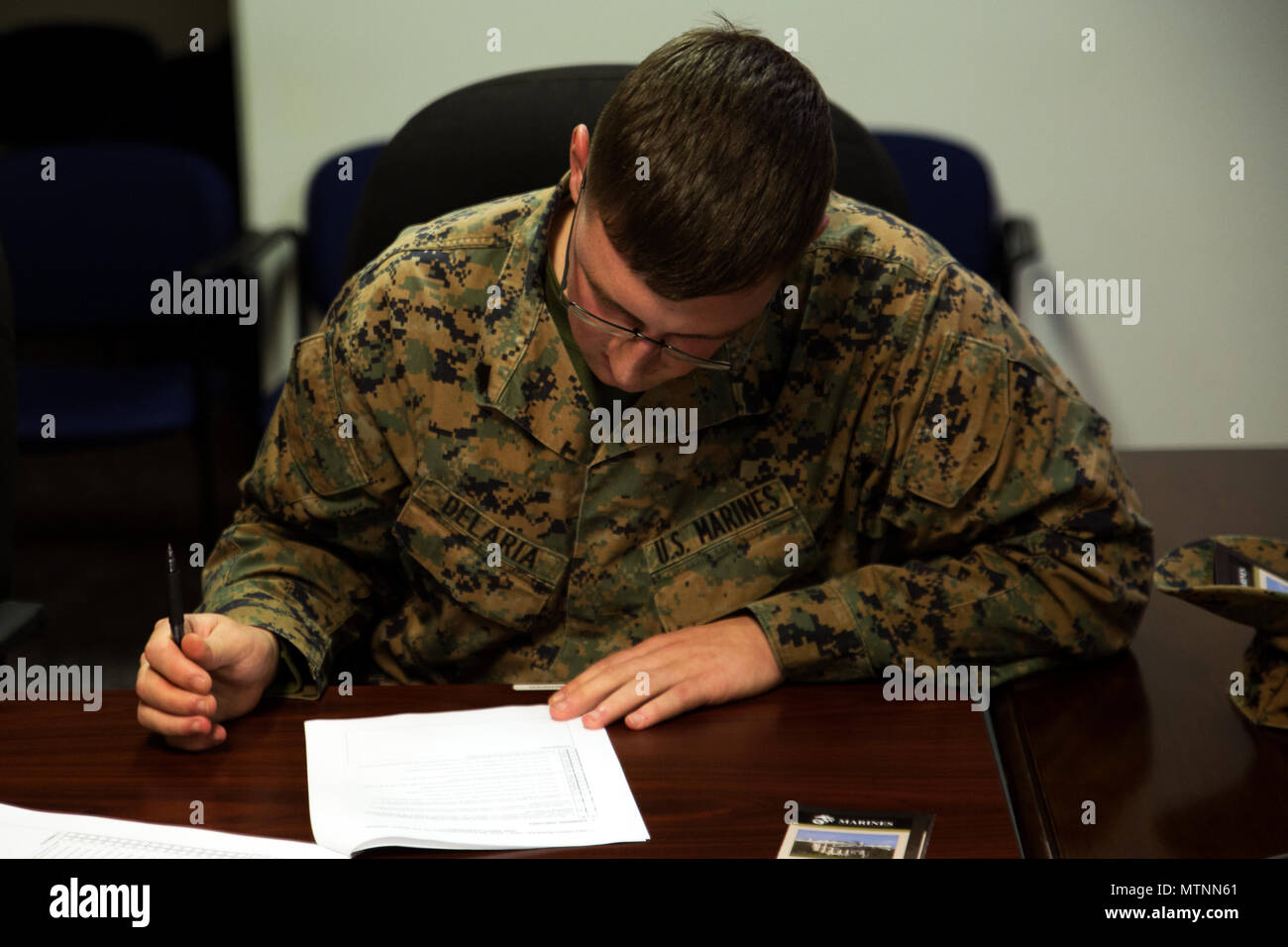 Sgt. Michael Delaria, fills out a pre-screening application for Marine ...