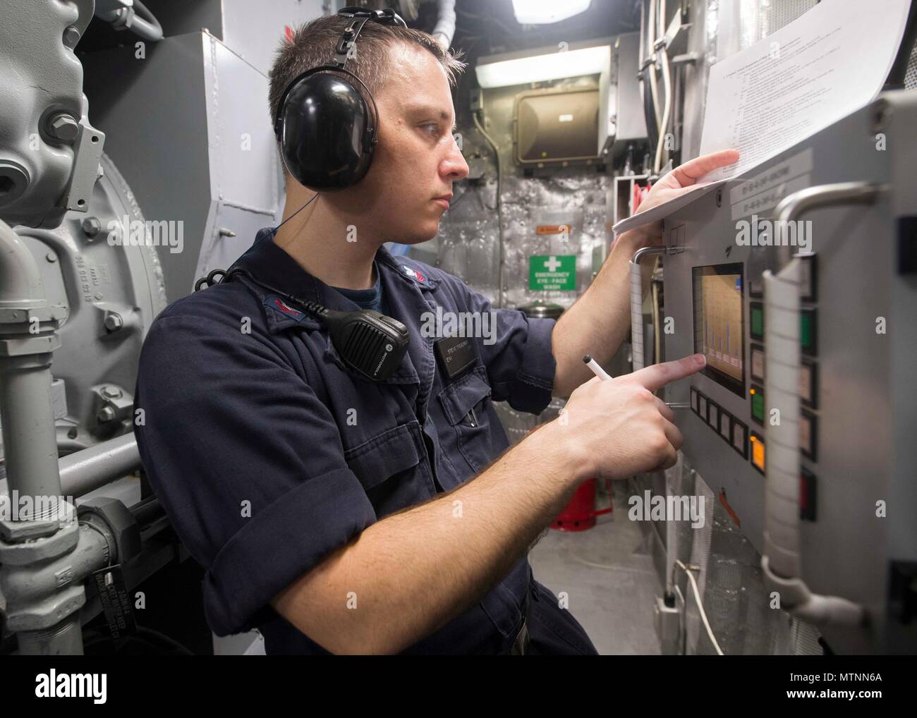 An Engineman 1st Class inspects a diesel generator aboard the littoral ...
