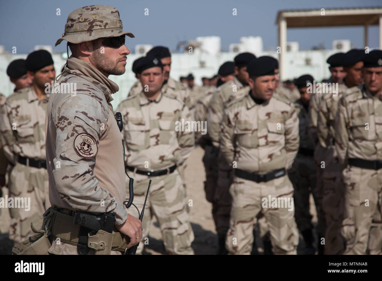 A Spanish trainer addresses a formation of new Iraqi security force ...