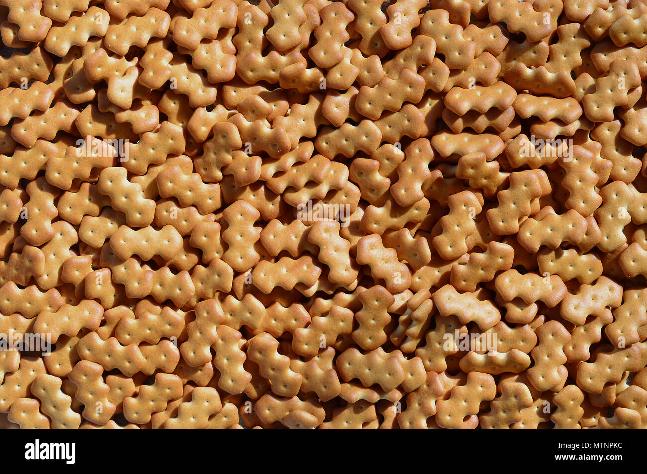 A huge bunch of salted biscuits of small sizes as a closed pattern or ...
