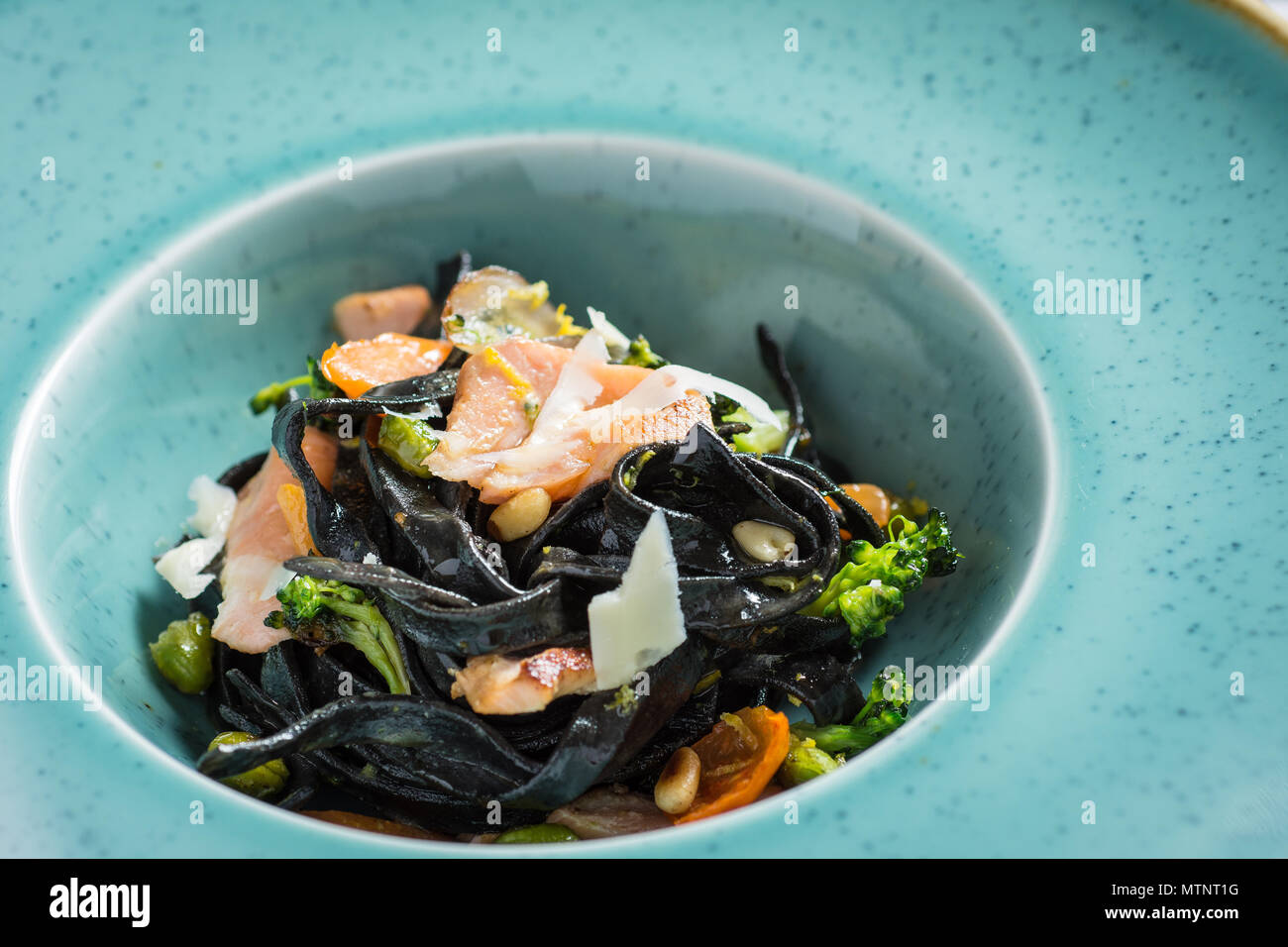 Black Pasta Spaghetti from Squid Ink with Salmon and Vegetables Stock ...