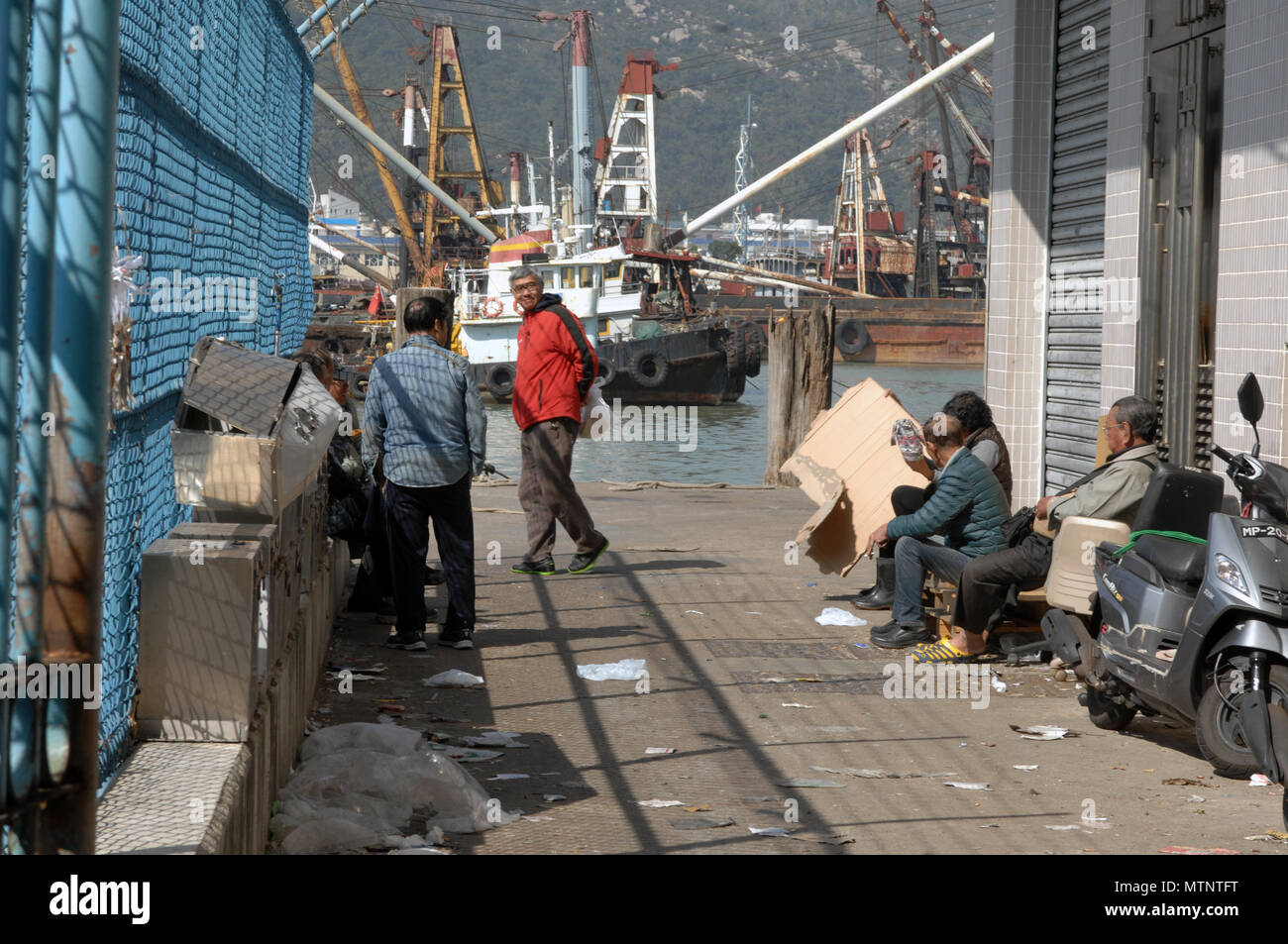 Dock workers, fishing wharf, Macau Stock Photo - Alamy
