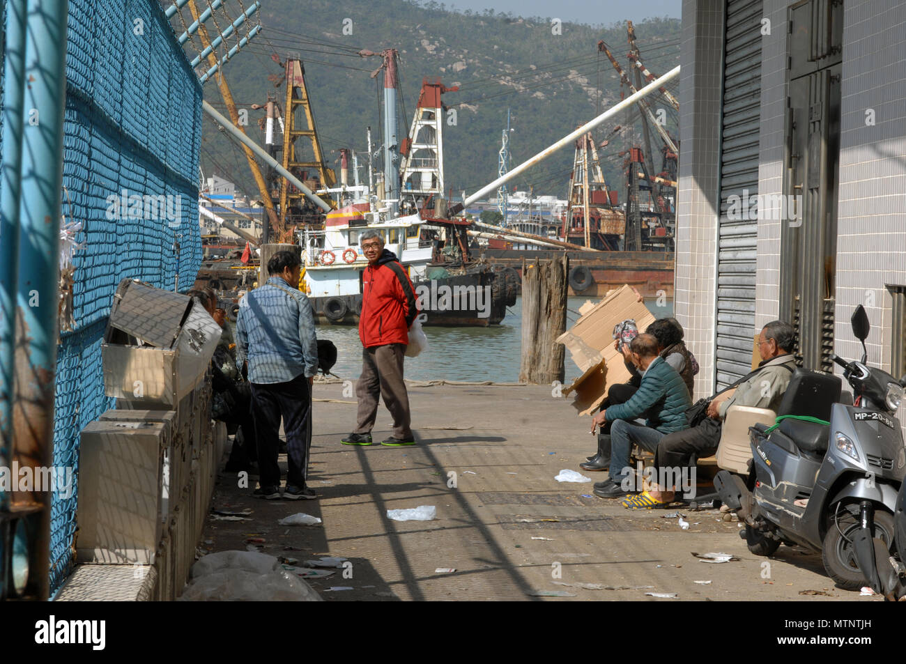 Dock workers, fishing wharf, Macau Stock Photo - Alamy
