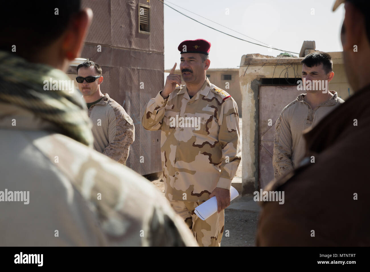 An Iraqi security forces officer speaks to soldiers during a graduation ...