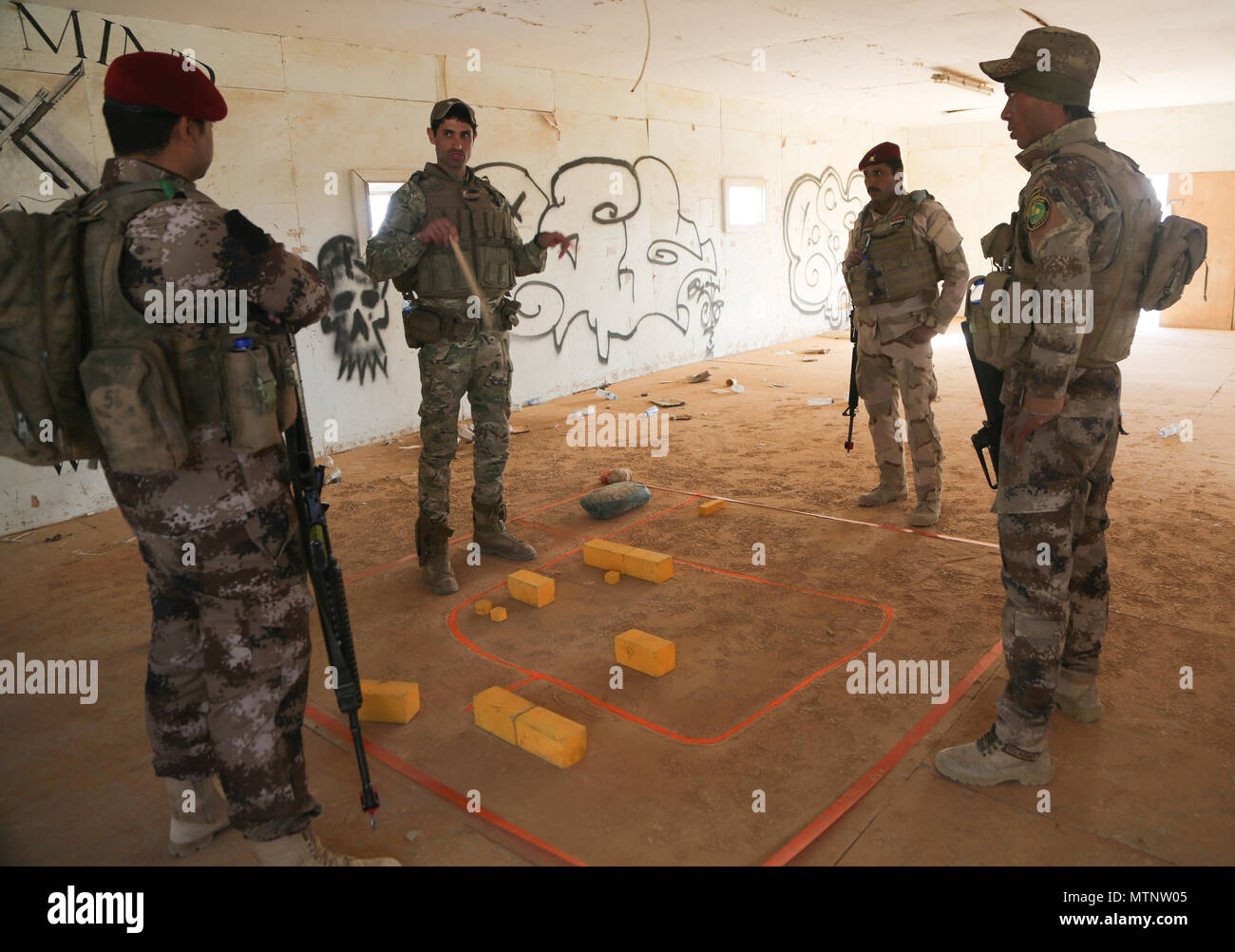 An Iraqi platoon commander, center, discusses scheme of maneuver to his ...