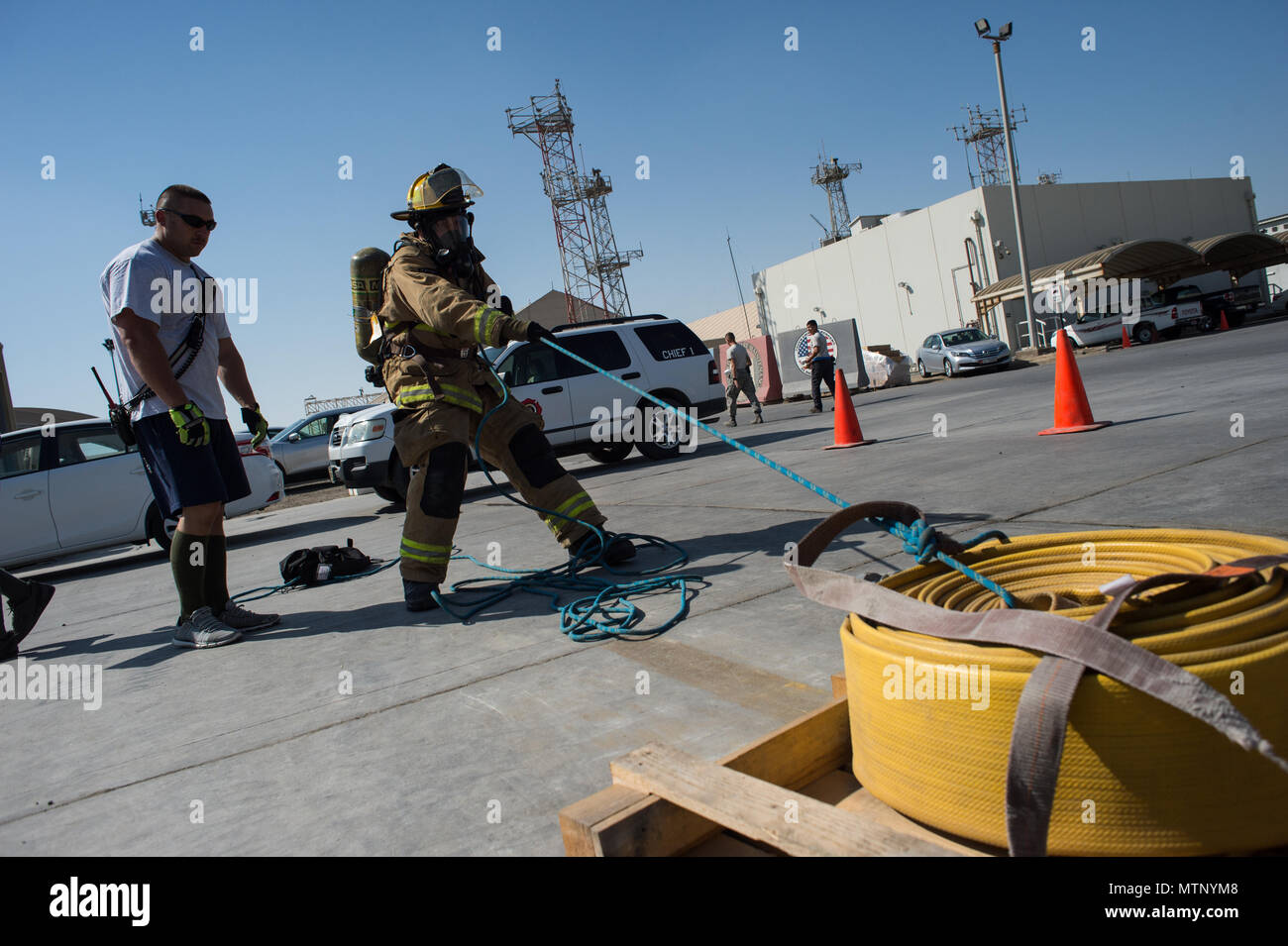A 380th Expeditionary Civil Engineer Squadron firefighter pulls an ...