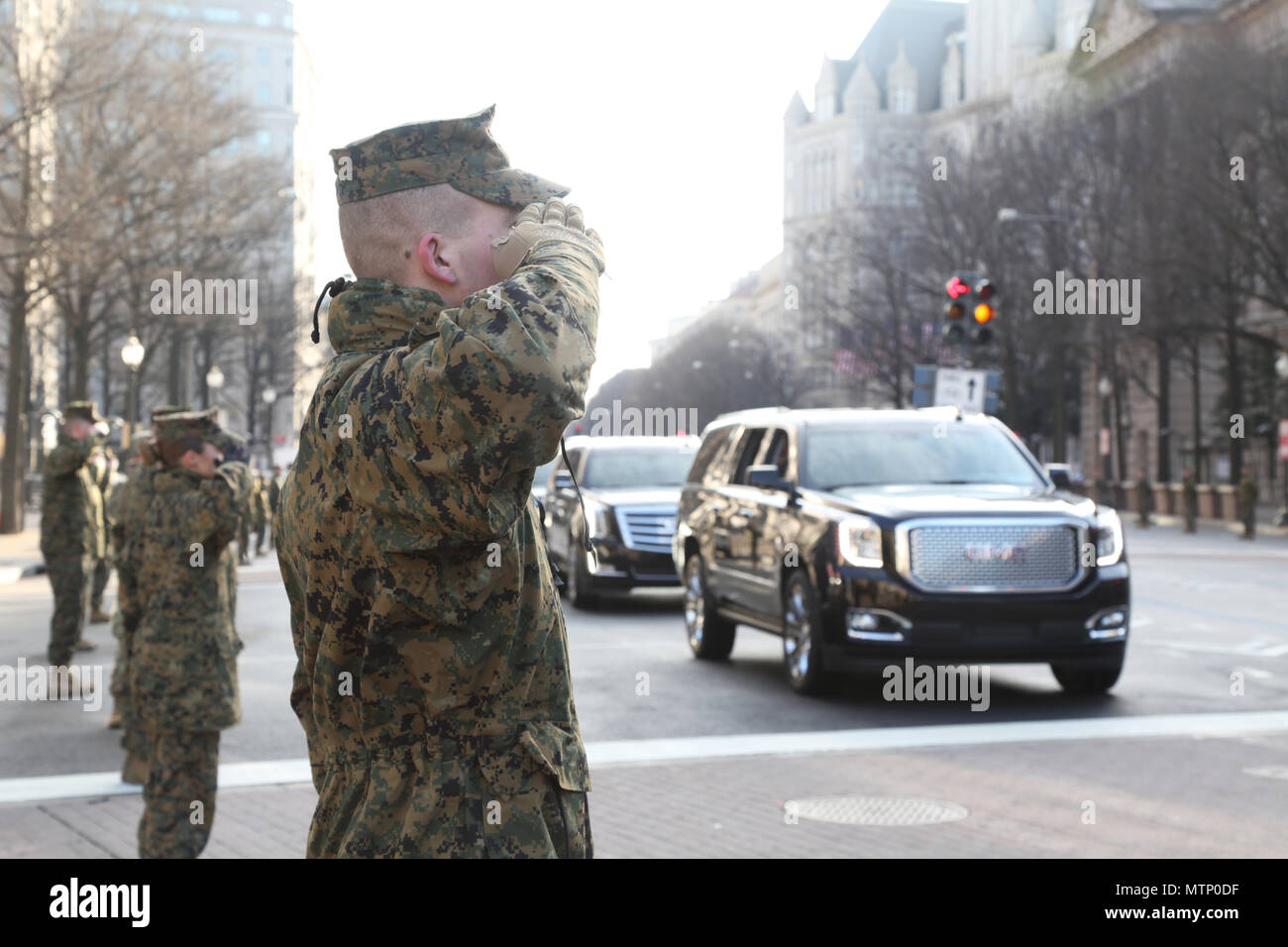 U.S. Marines salute the Presidential motorcade near Freedom Plaza along ...