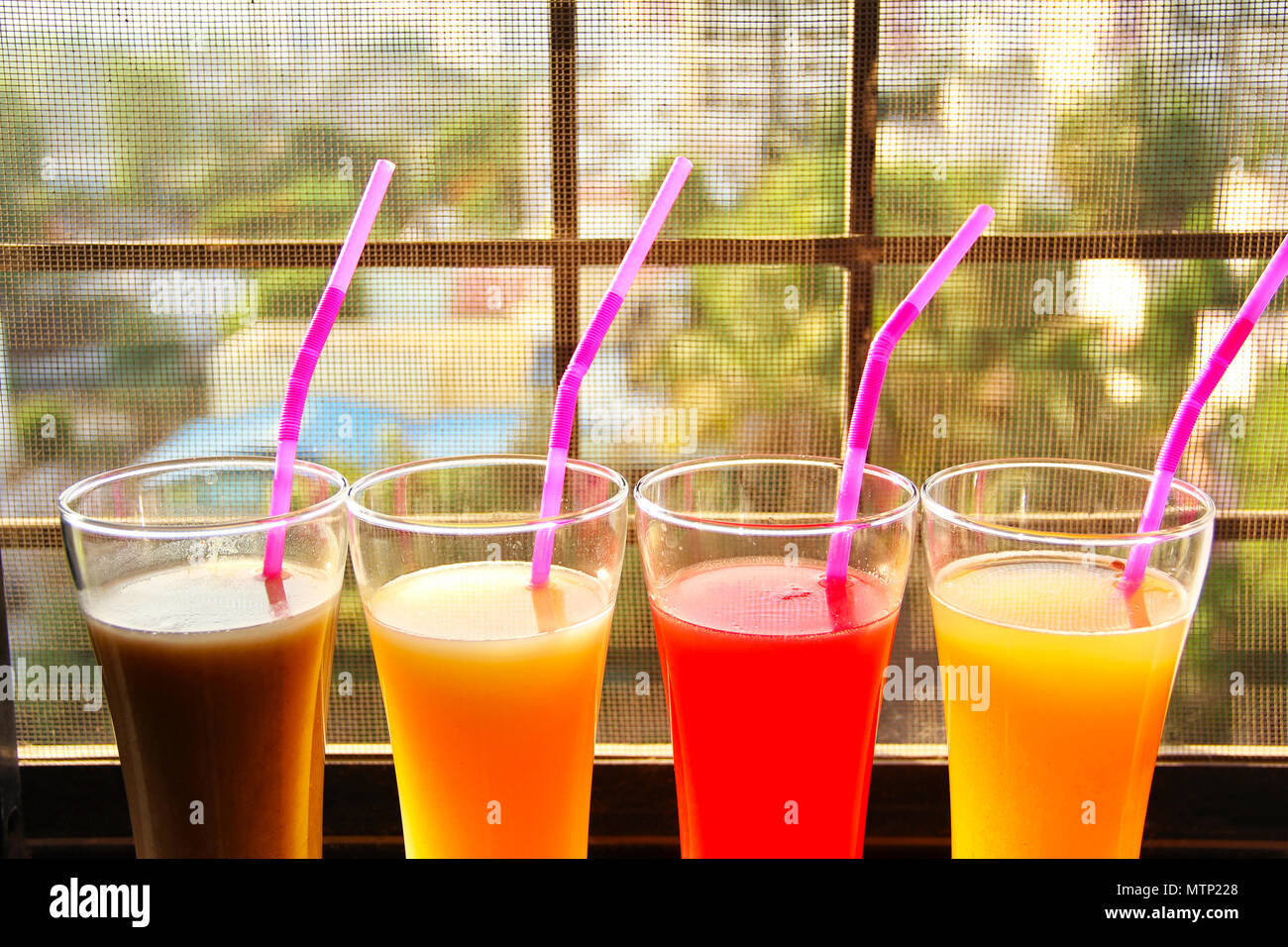 Close view of glasses filled with fruit juices of sapota, mango ...
