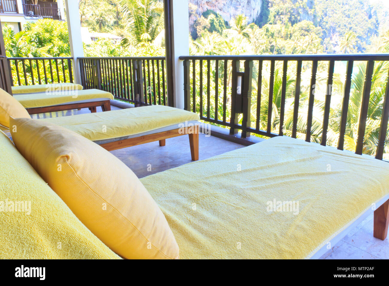 Yellow sunbeds on the balcony room in island Stock Photo - Alamy