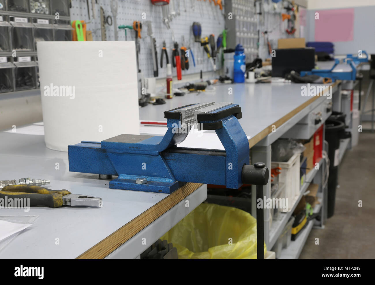 Workbench of a workshop and a blue vise to repair Stock Photo - Alamy