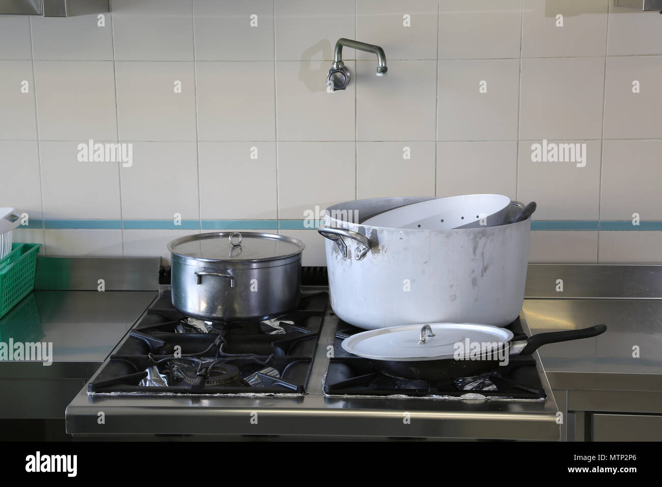 Large industrial cooker of a kitchen of a restaurant with big pots ...