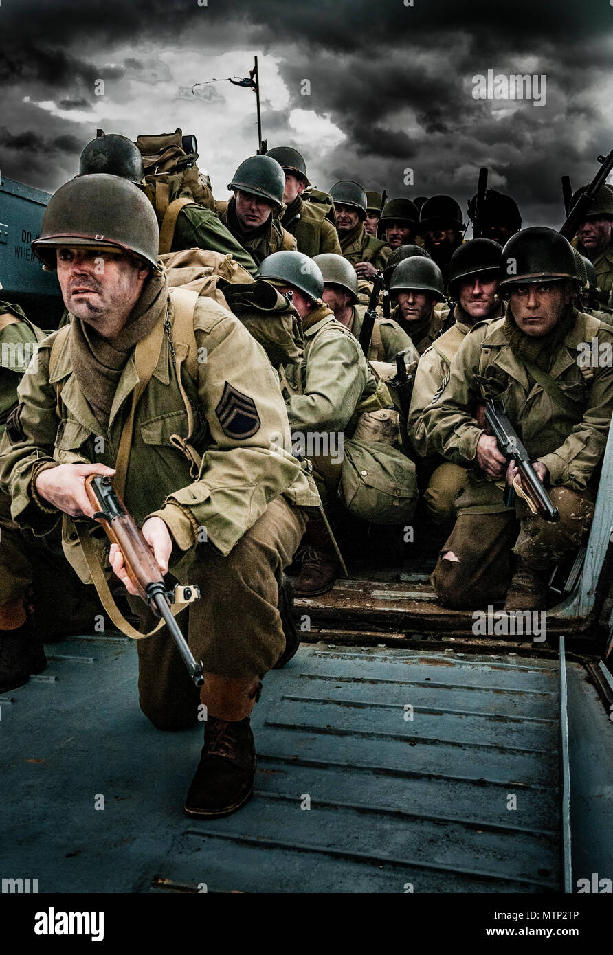 Group of an American GI soldier from World War Two in a landing craft ...
