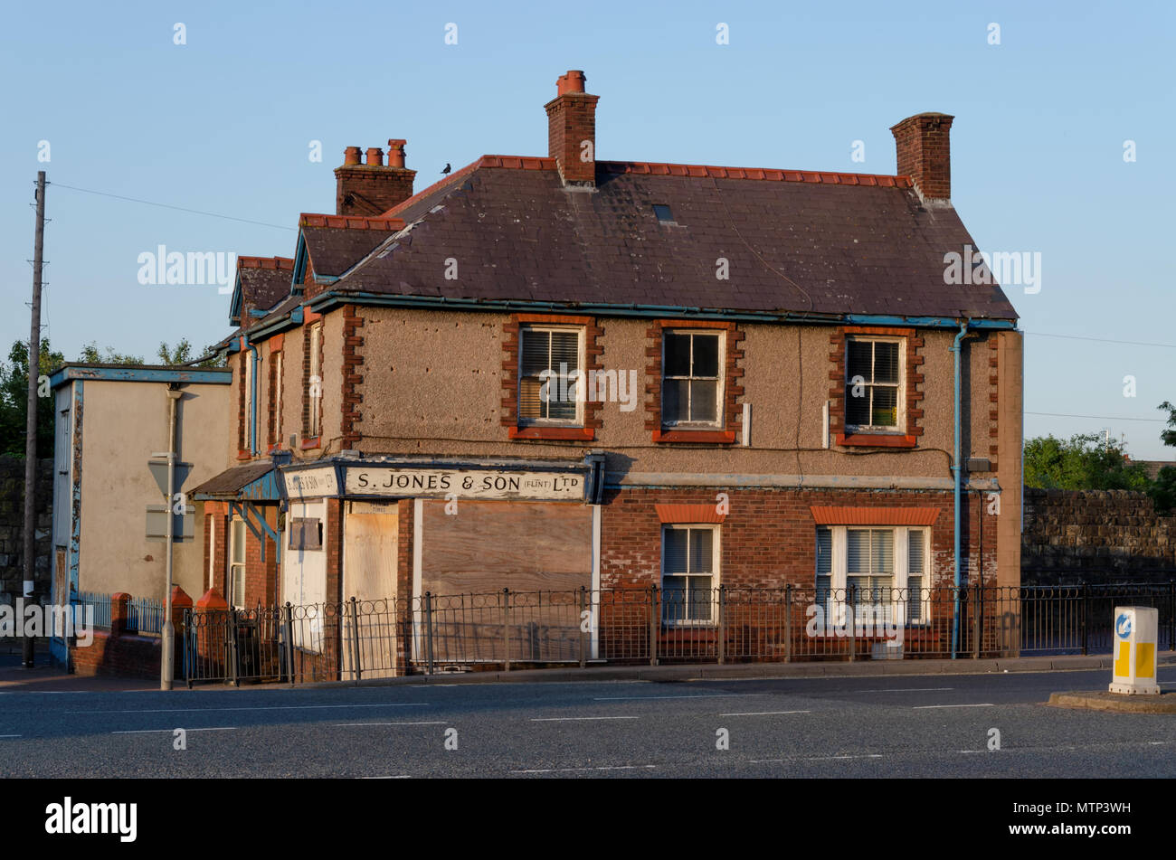 Flint, UK: May 22, 2018: A boarded up and derelict shop and newsagent ...