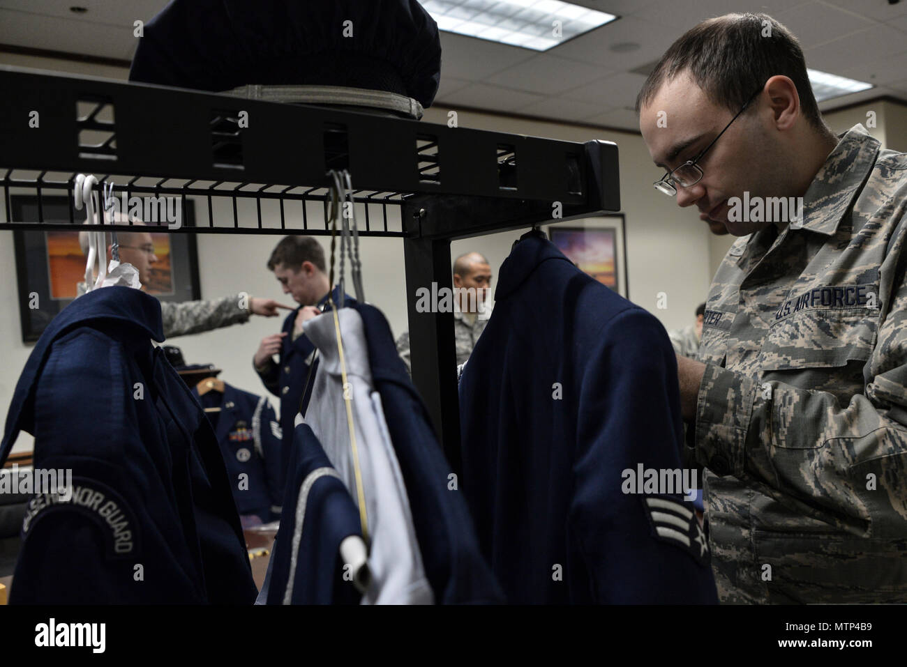 Senior Airman Jared, 41st Intelligence Squadron, adjusts his ribbons ...
