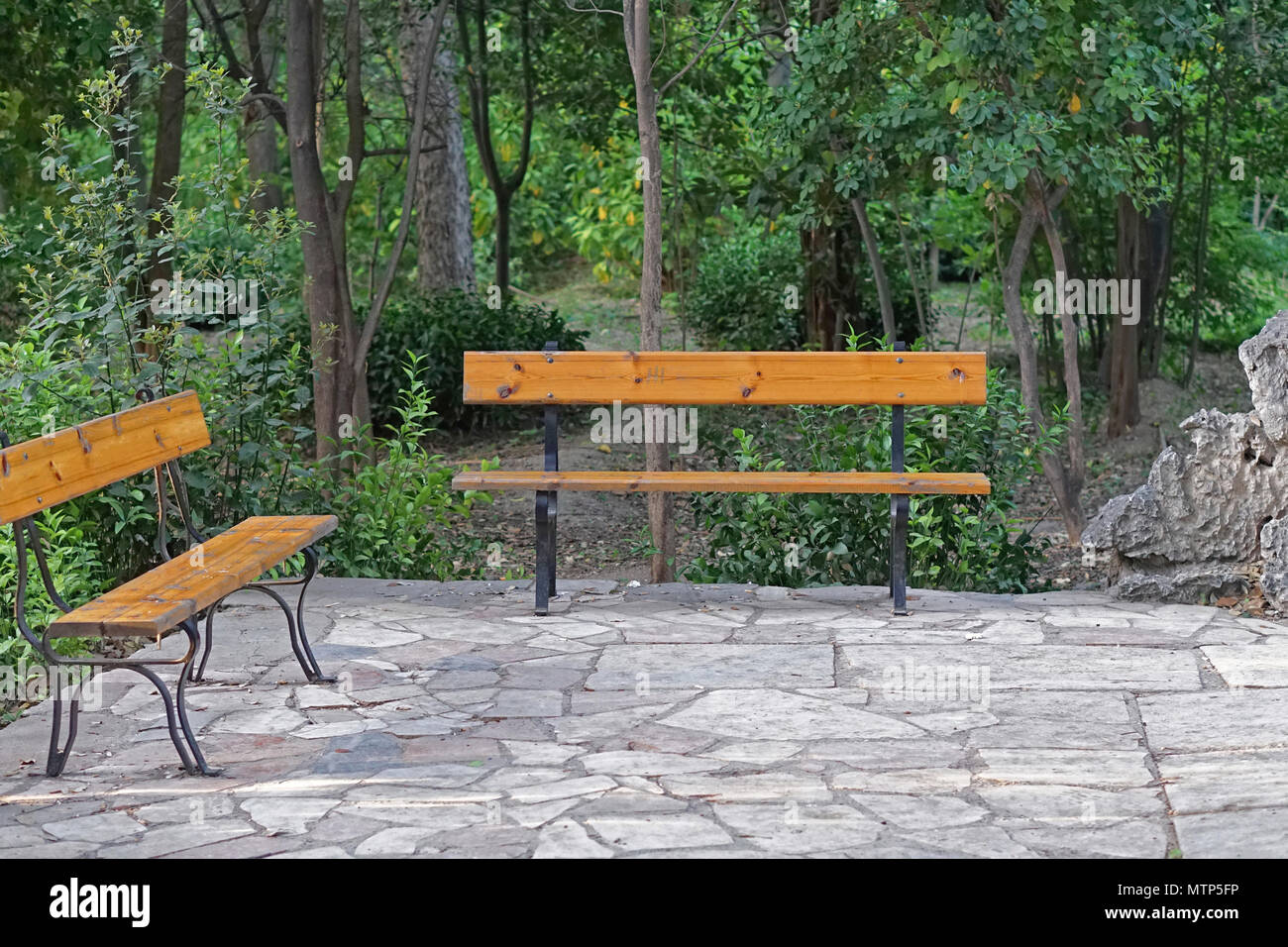 Two benches with patio in park Stock Photo - Alamy