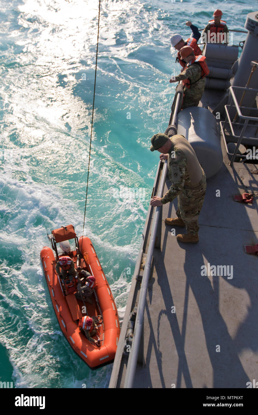 U.S. Army Soldiers, with the 411th Transportation Detachment, lower ...