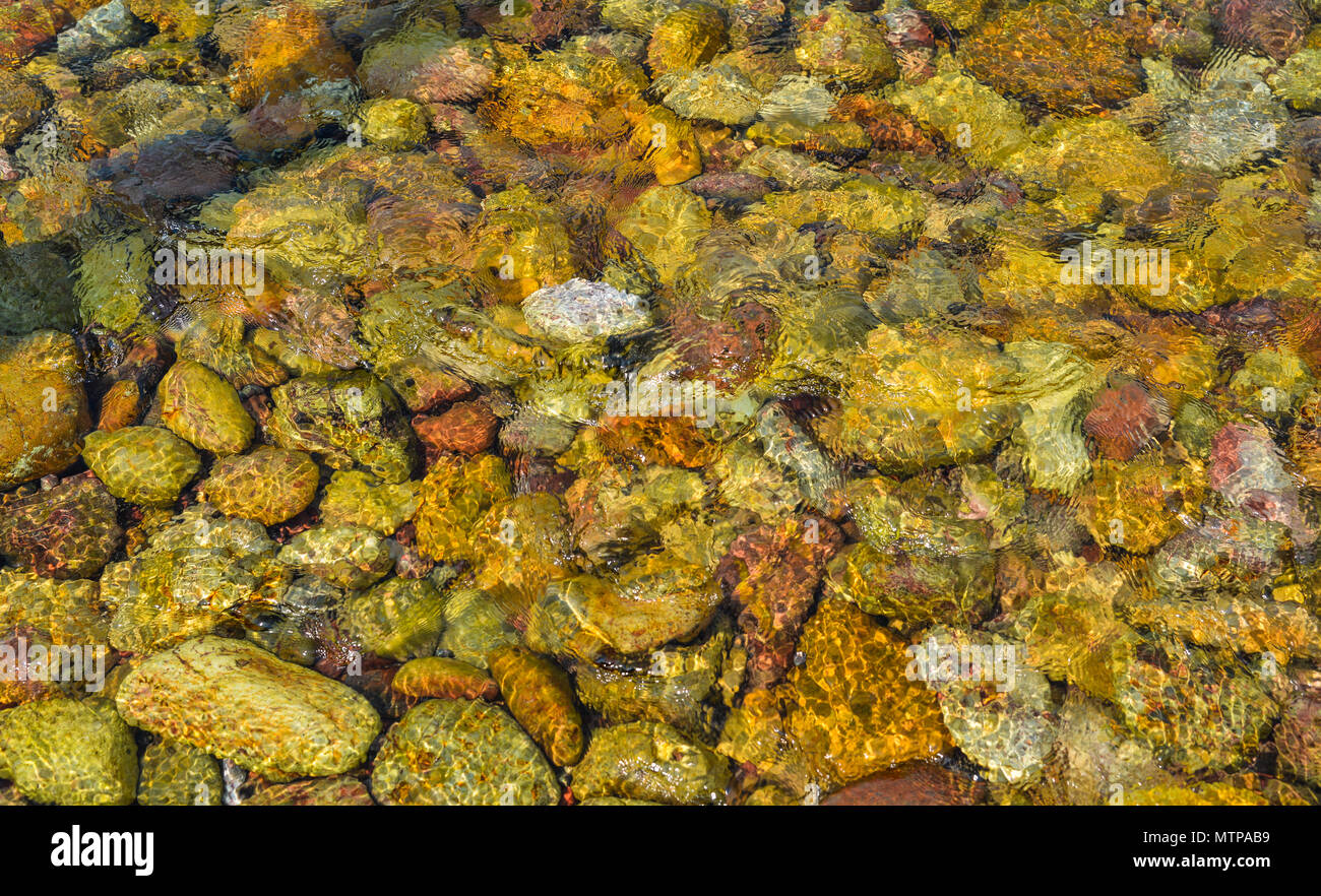 Sea pebble stones and multicolor rocks on beach at sunny day Stock ...