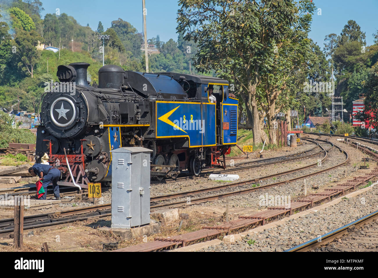 Coonoor, India - March 4, 2018: Railwaymen checking one of the steam ...