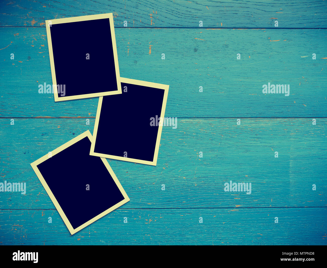 Old photographs on a blue rustic wooden table, travel or vacation ...