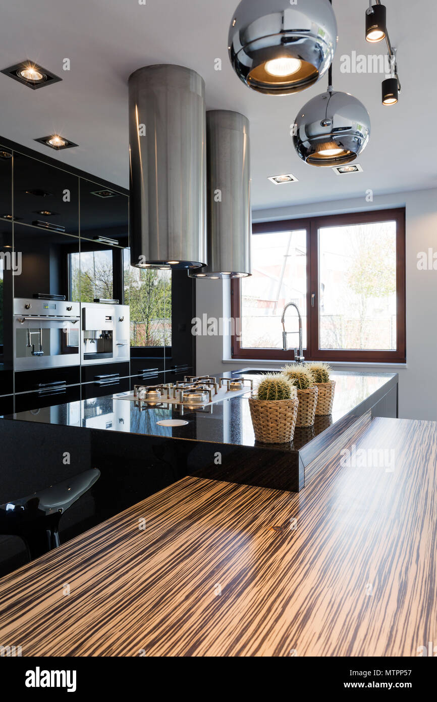 Black high-gloss open kitchen with lighting in modern style Stock Photo ...