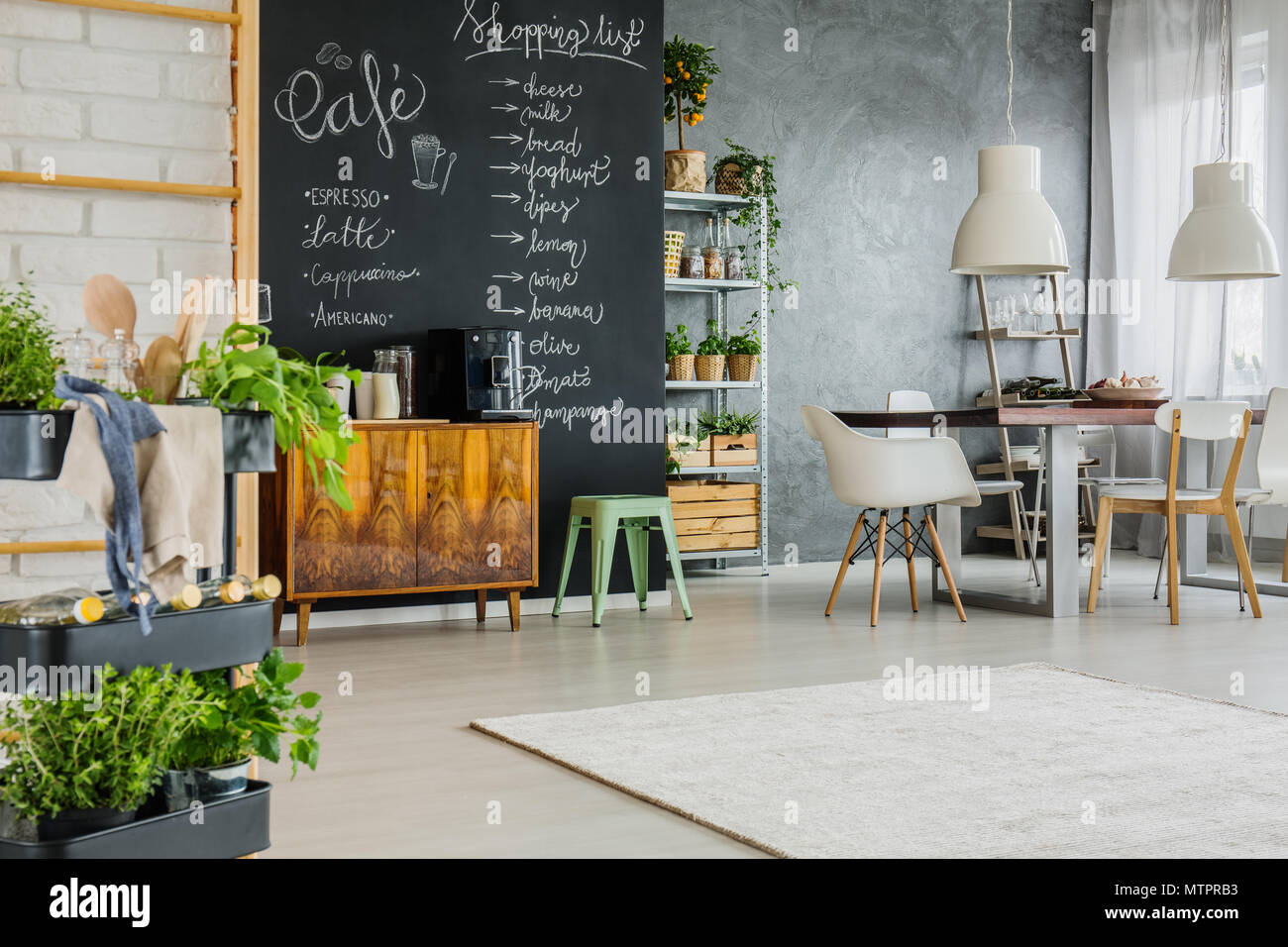 Cozy loft kitchen with big wooden family table Stock Photo - Alamy
