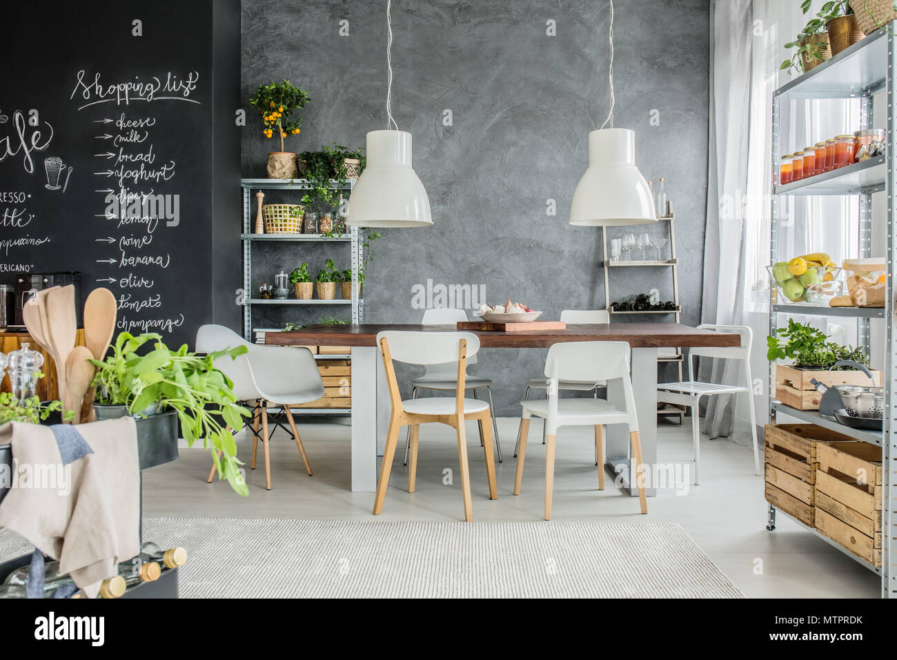 Nice and homey dining room with kitchen annex Stock Photo - Alamy
