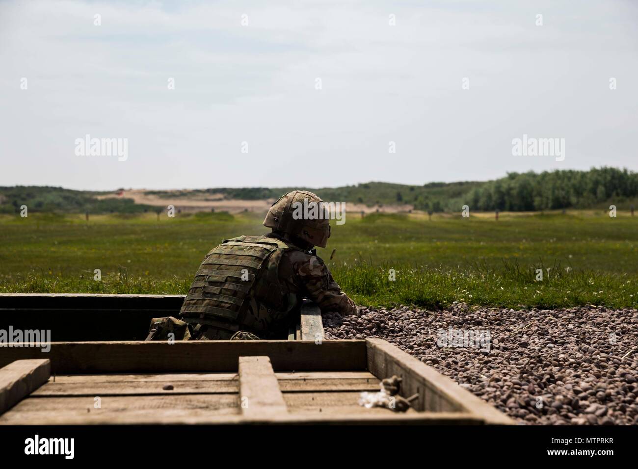 A Royal Marine with Commando Training Center, fires down range with a ...