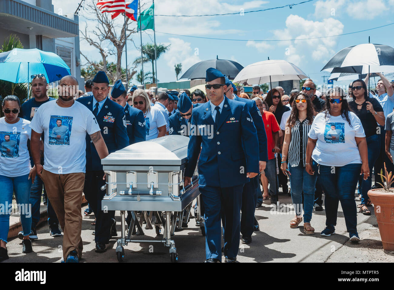 Airmen and local community members carry the casket for Senior Airman ...