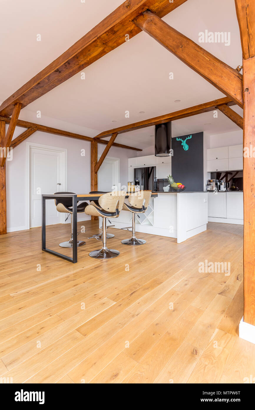 Kitchenette with blue decor on black wall and dining table with bar ...